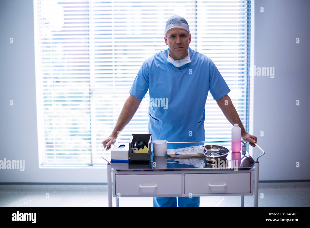 Portrait of male surgeon holding trolley Stock Photo - Alamy