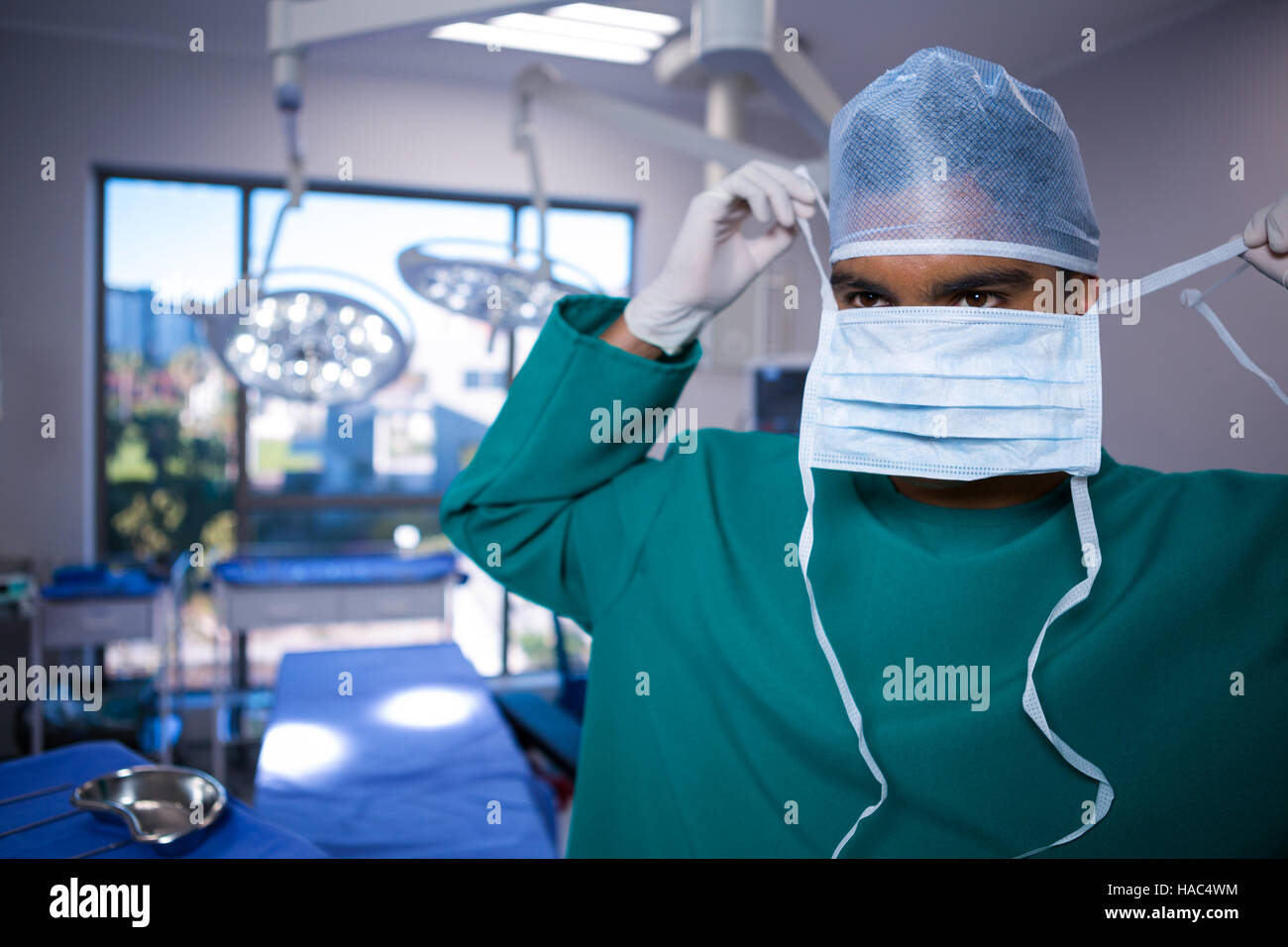 Male surgeon wearing surgical mask in operation theater Stock Photo - Alamy
