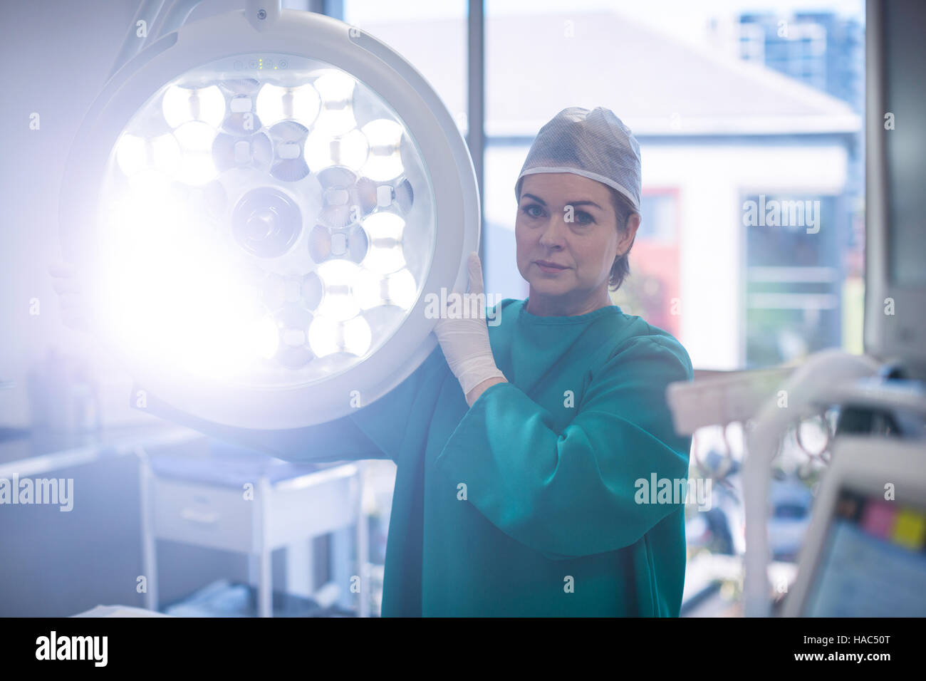 Portrait of surgeon adjusting surgical light in operation room Stock ...