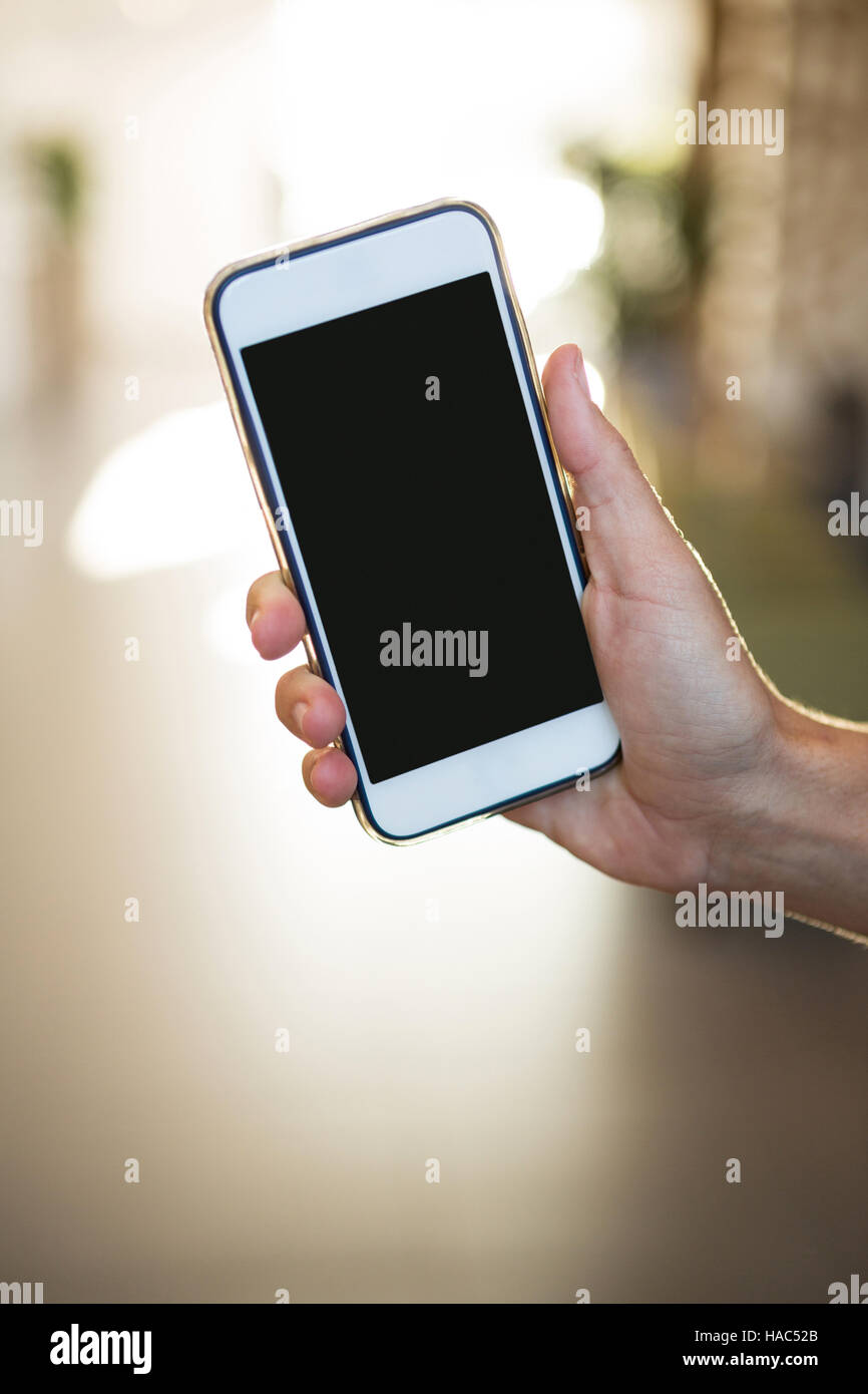 Woman showing mobile phone Stock Photo - Alamy