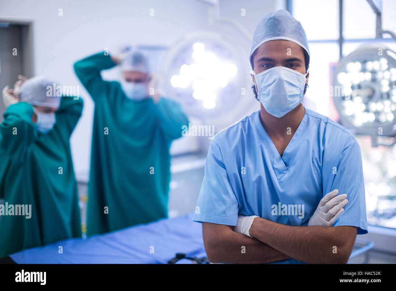 Portrait of surgeon standing with arms crossed in operation room Stock ...