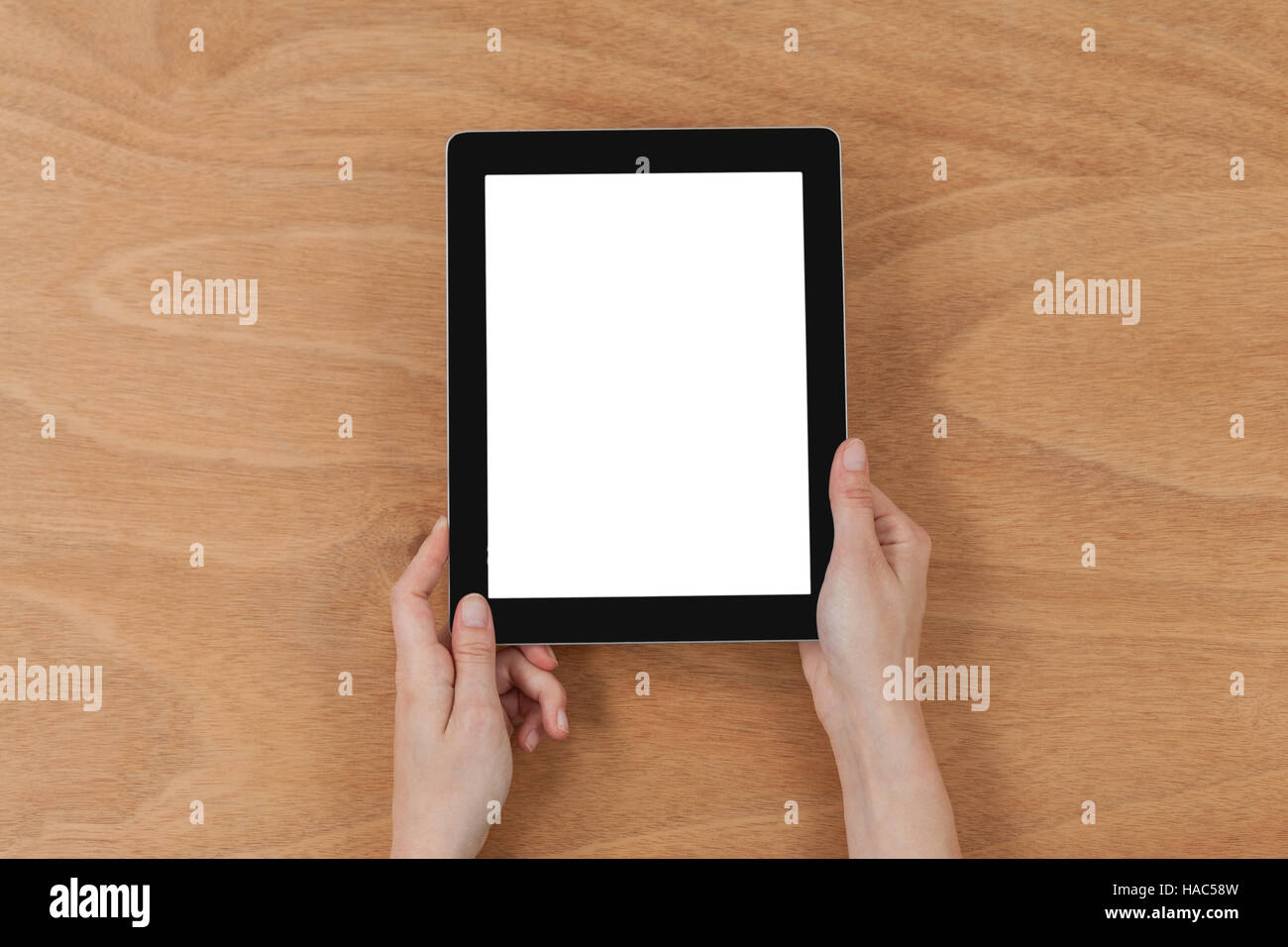 Hands holding digital tablet Stock Photo - Alamy