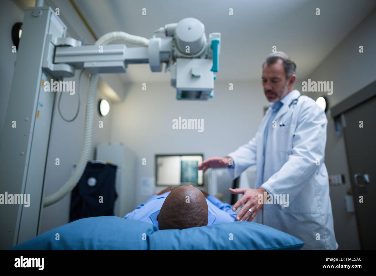 Male doctor taking an x-ray of patient Stock Photo - Alamy