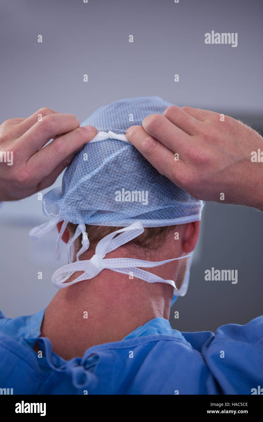 Surgeon tying surgical mask in operation room Stock Photo - Alamy