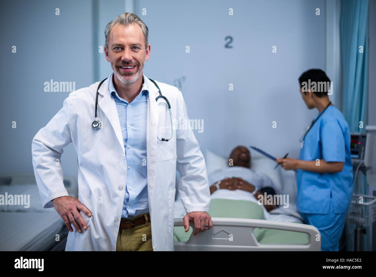 Portrait of doctor standing in ward Stock Photo - Alamy