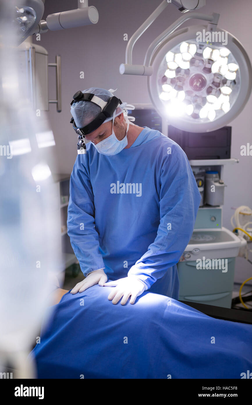 Surgeon examining a patient in operation room Stock Photo - Alamy