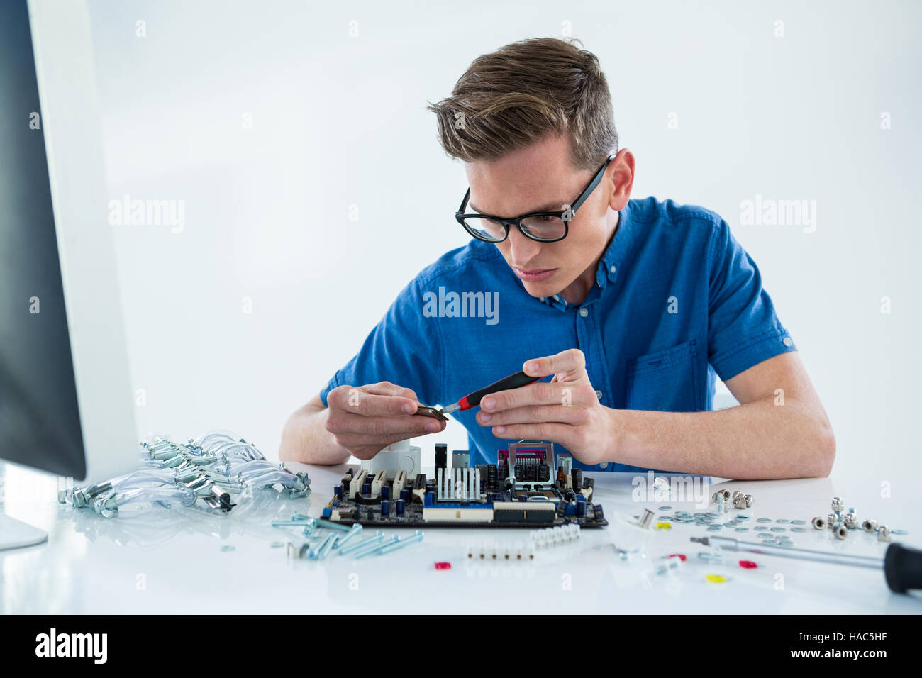 Computer technician repairing motherboard Stock Photo - Alamy