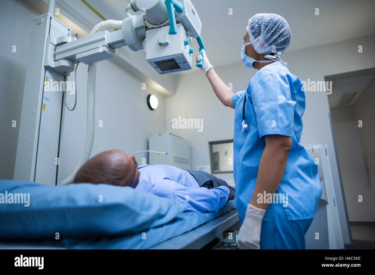 Female doctor sets up the machine to x-ray over patient Stock Photo - Alamy