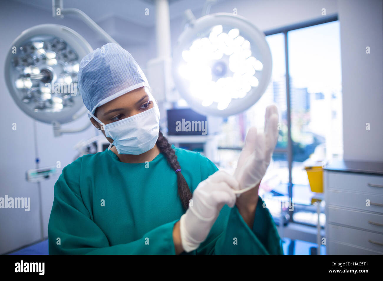 Surgeon wearing surgical gloves in operation theater Stock Photo - Alamy