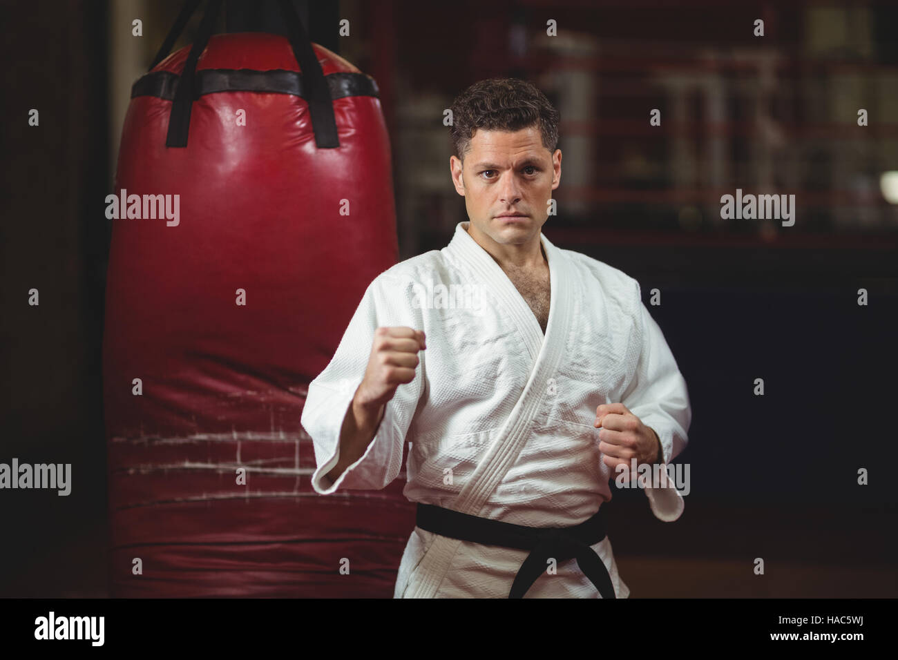 Karate player practicing in fitness studio Stock Photo - Alamy