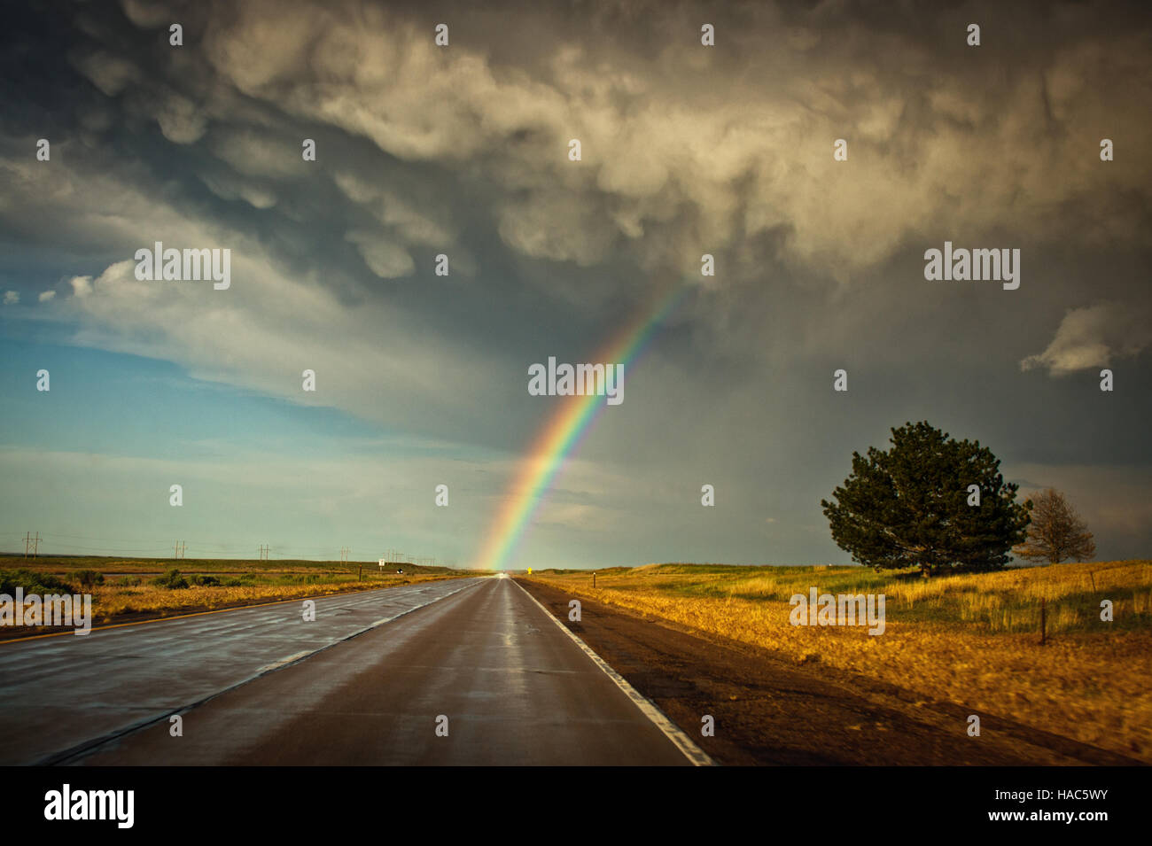 A rainbow lays at the end of I-70 outside of Crook, Colorado as ...
