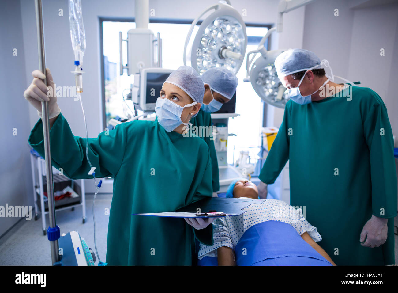Surgical team adjusting iv drip hi-res stock photography and images - Alamy