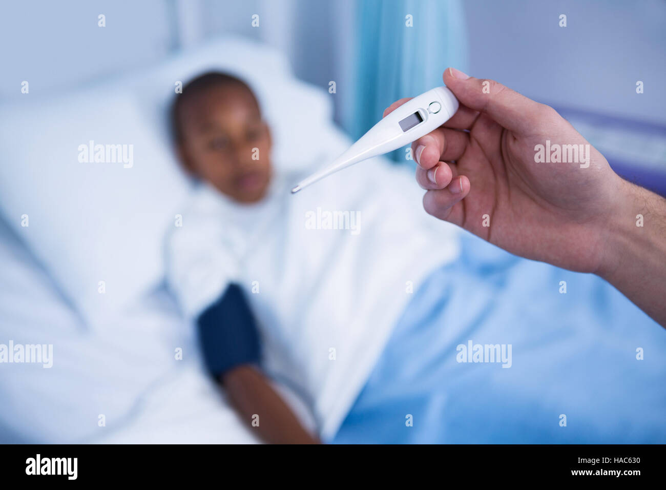 Hand of nurse holding thermometer in ward Stock Photo - Alamy