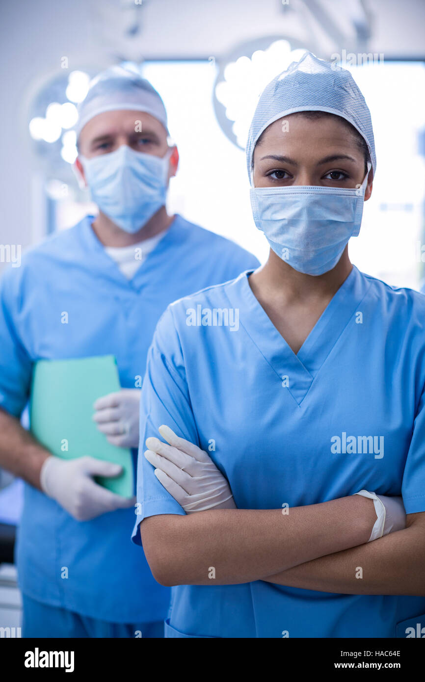 Portrait of female surgeon standing with arms crossed in operation room ...