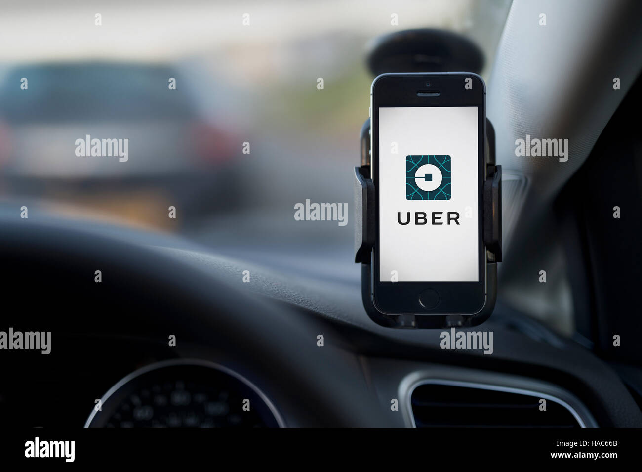 The interior of an Uber taxi with an iPhone fixed to the car's ...