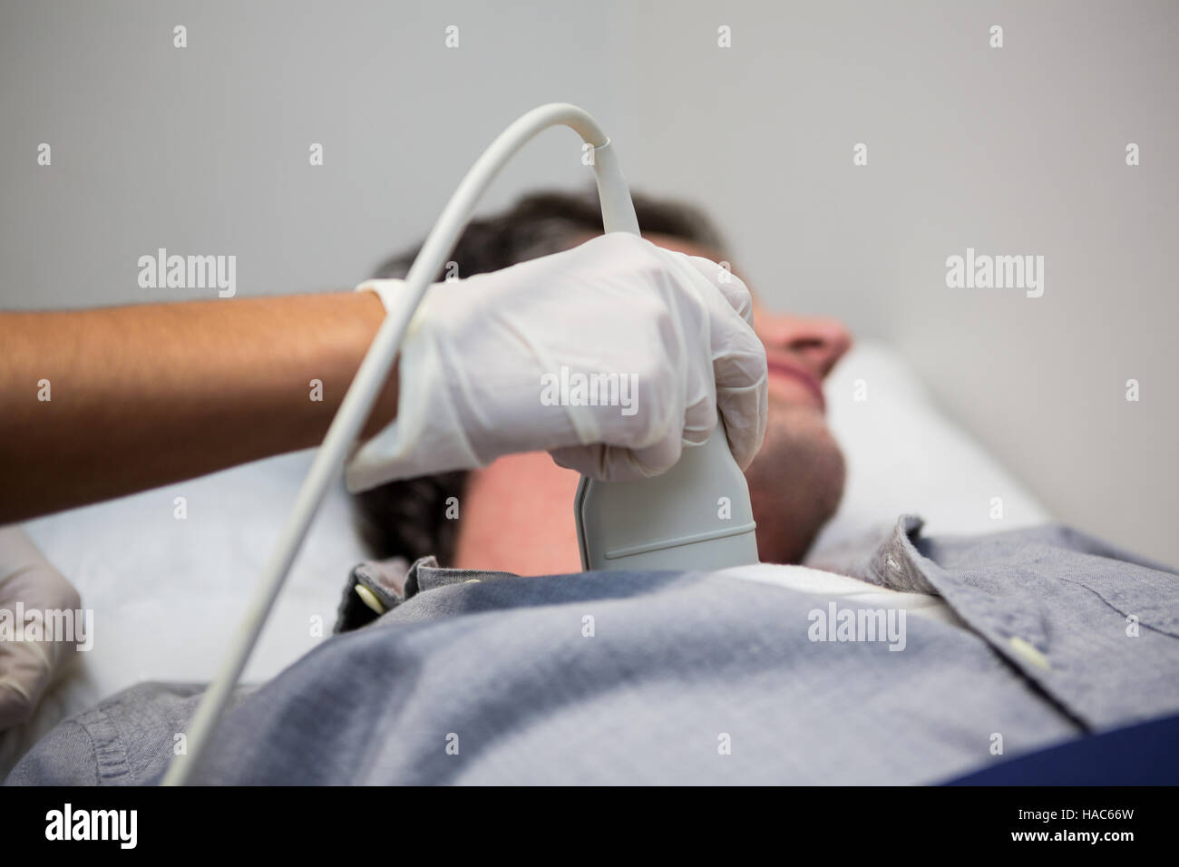 Doctors performing a doppler sonography on patient Stock Photo - Alamy