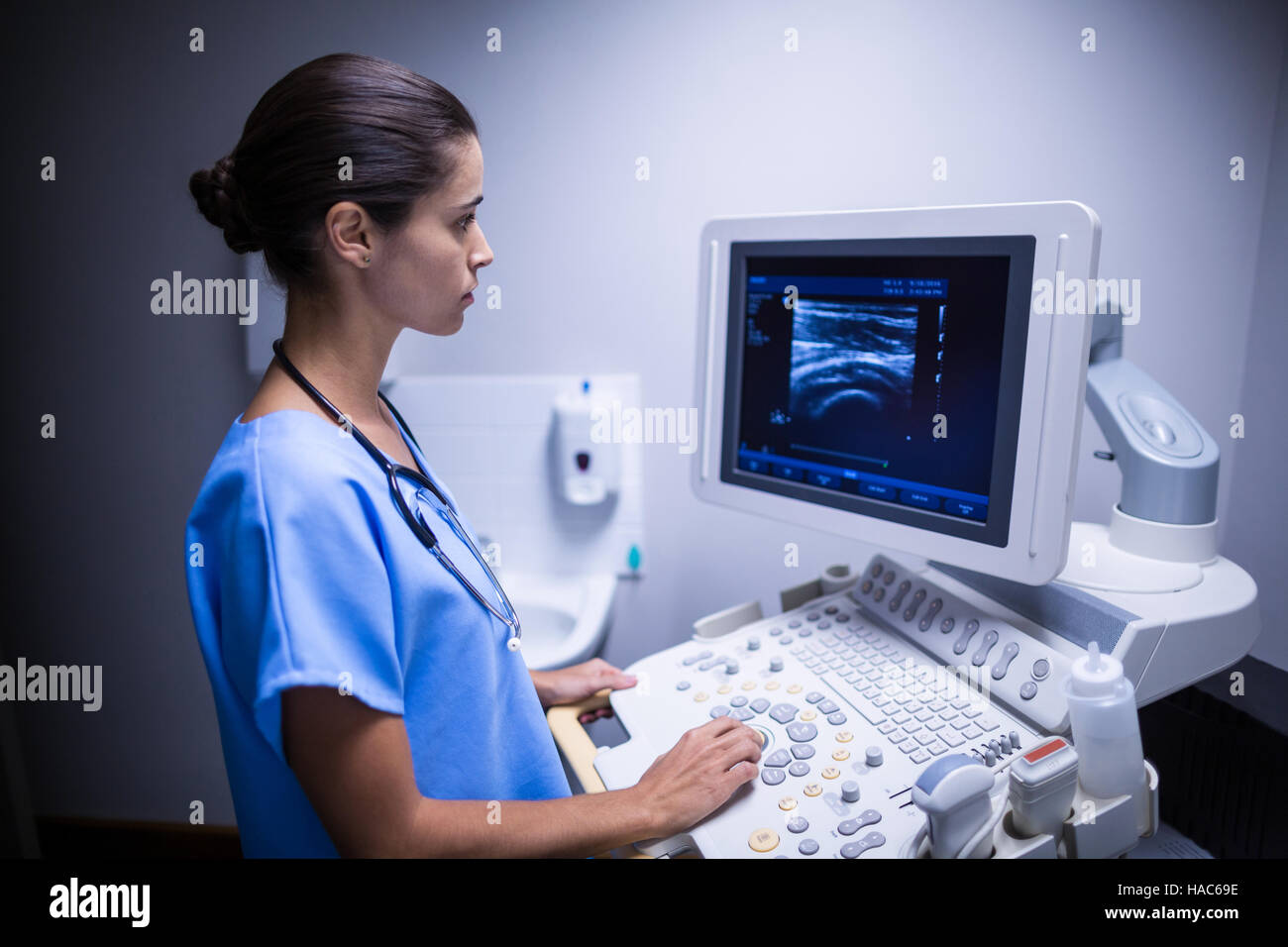 Nurse examining ultrasonic monitor Stock Photo - Alamy