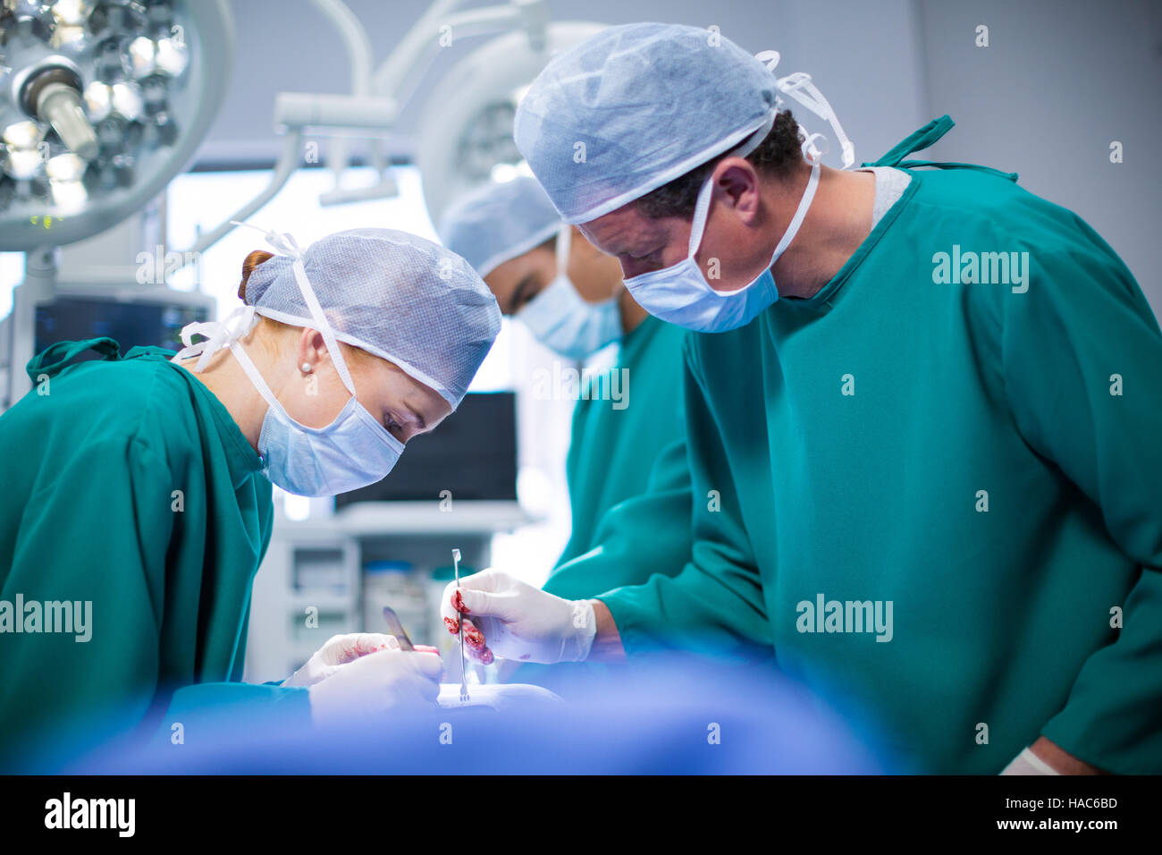 Surgeons performing operation in operation theater Stock Photo - Alamy