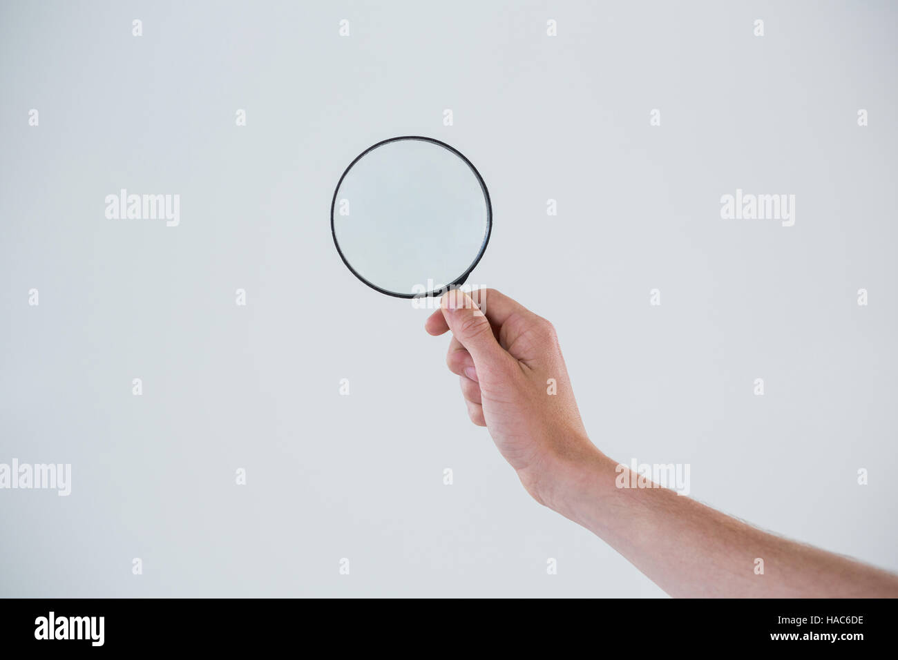Hand holding magnifying glass Stock Photo - Alamy