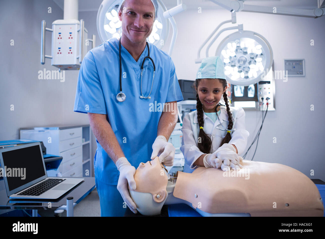 Portrait of doctor and girl examining a dummy Stock Photo - Alamy