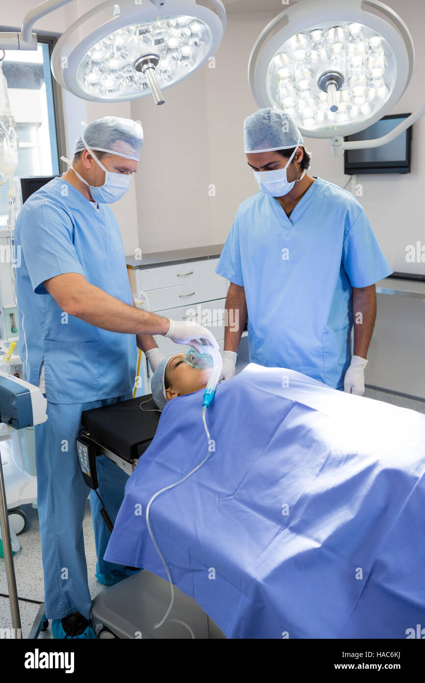 Doctor placing an oxygen mask on the face of a patient Stock Photo - Alamy