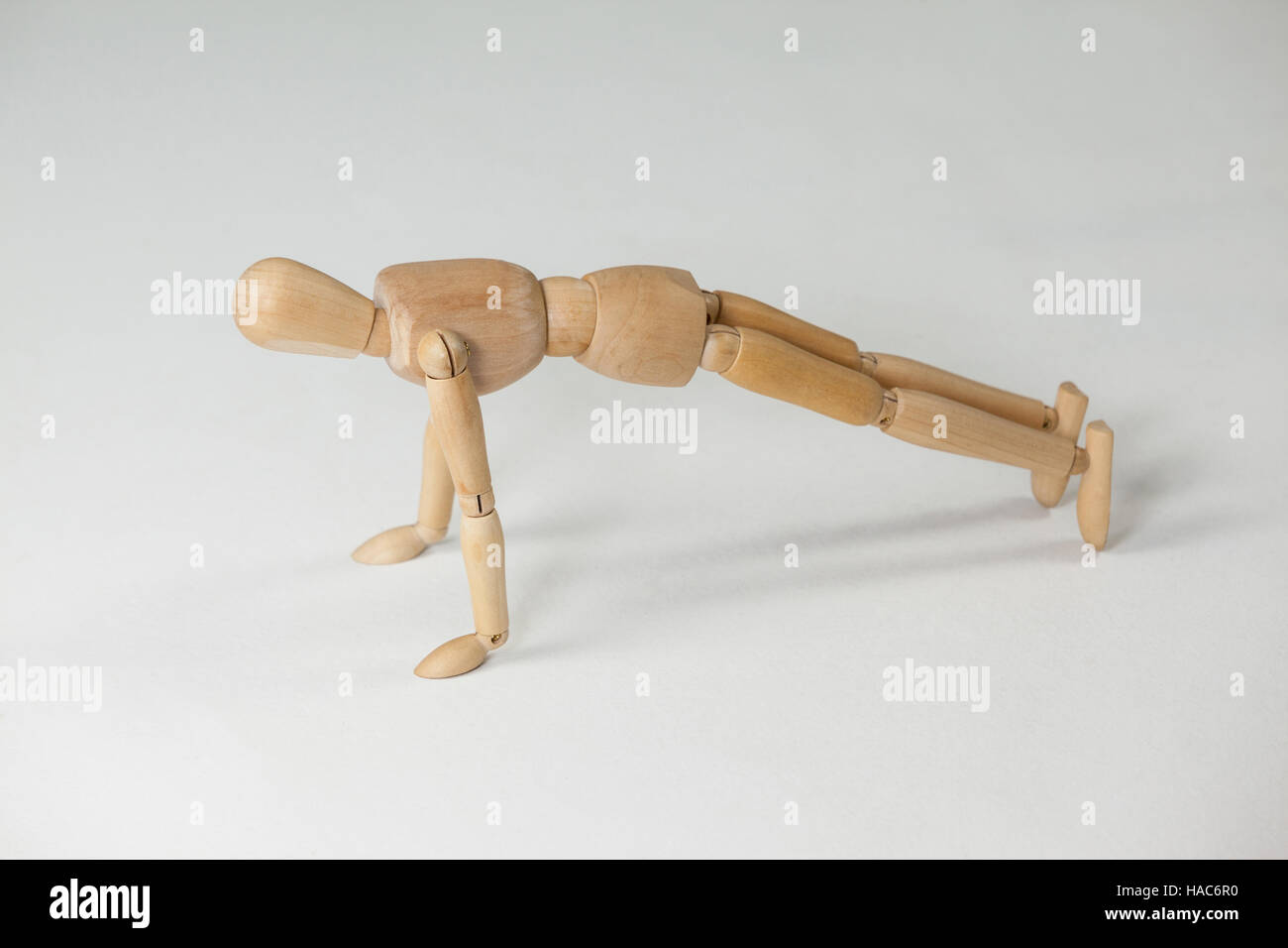 Wooden figurine performing push-ups Stock Photo - Alamy