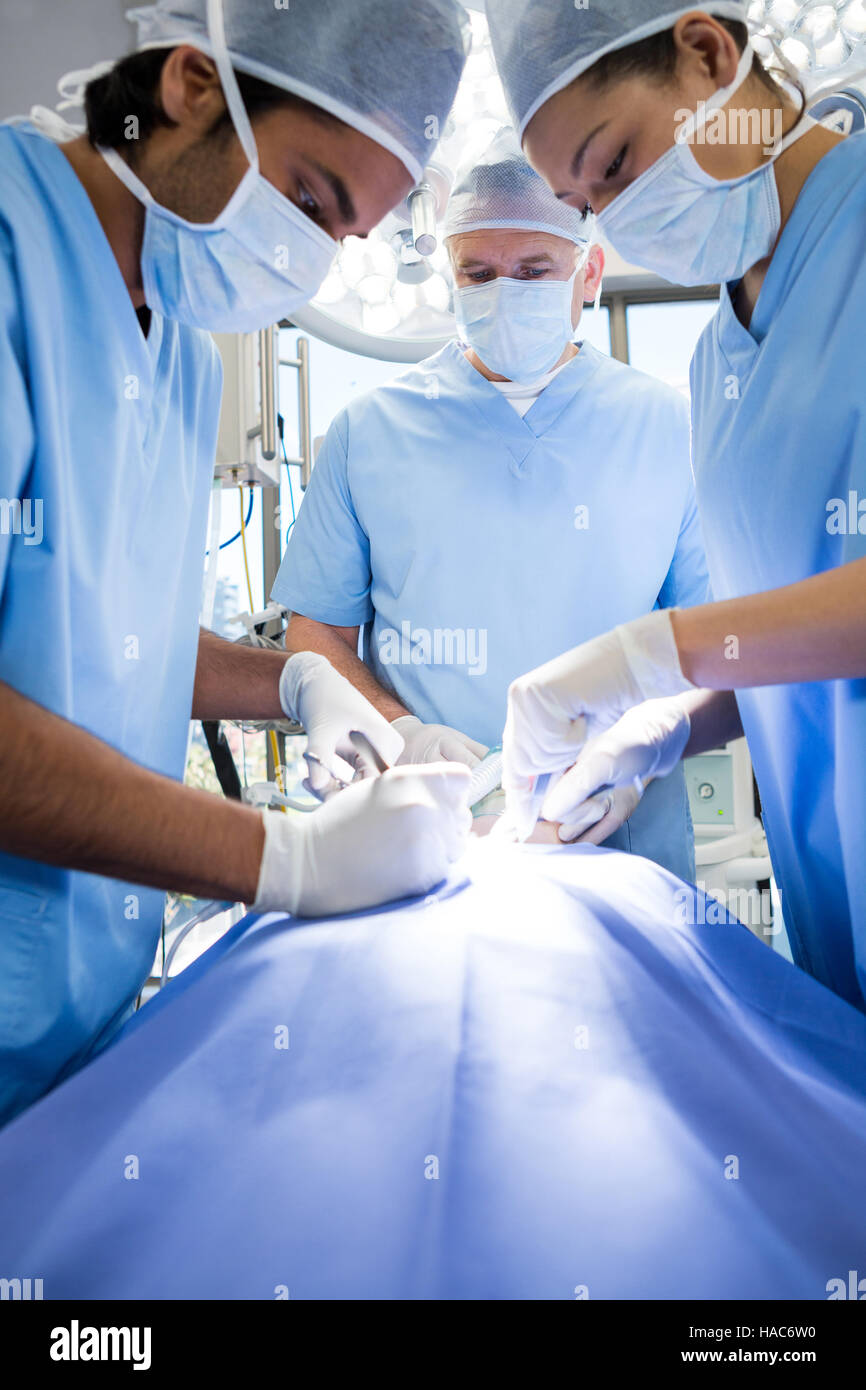 Surgeons performing operation in operation room Stock Photo - Alamy
