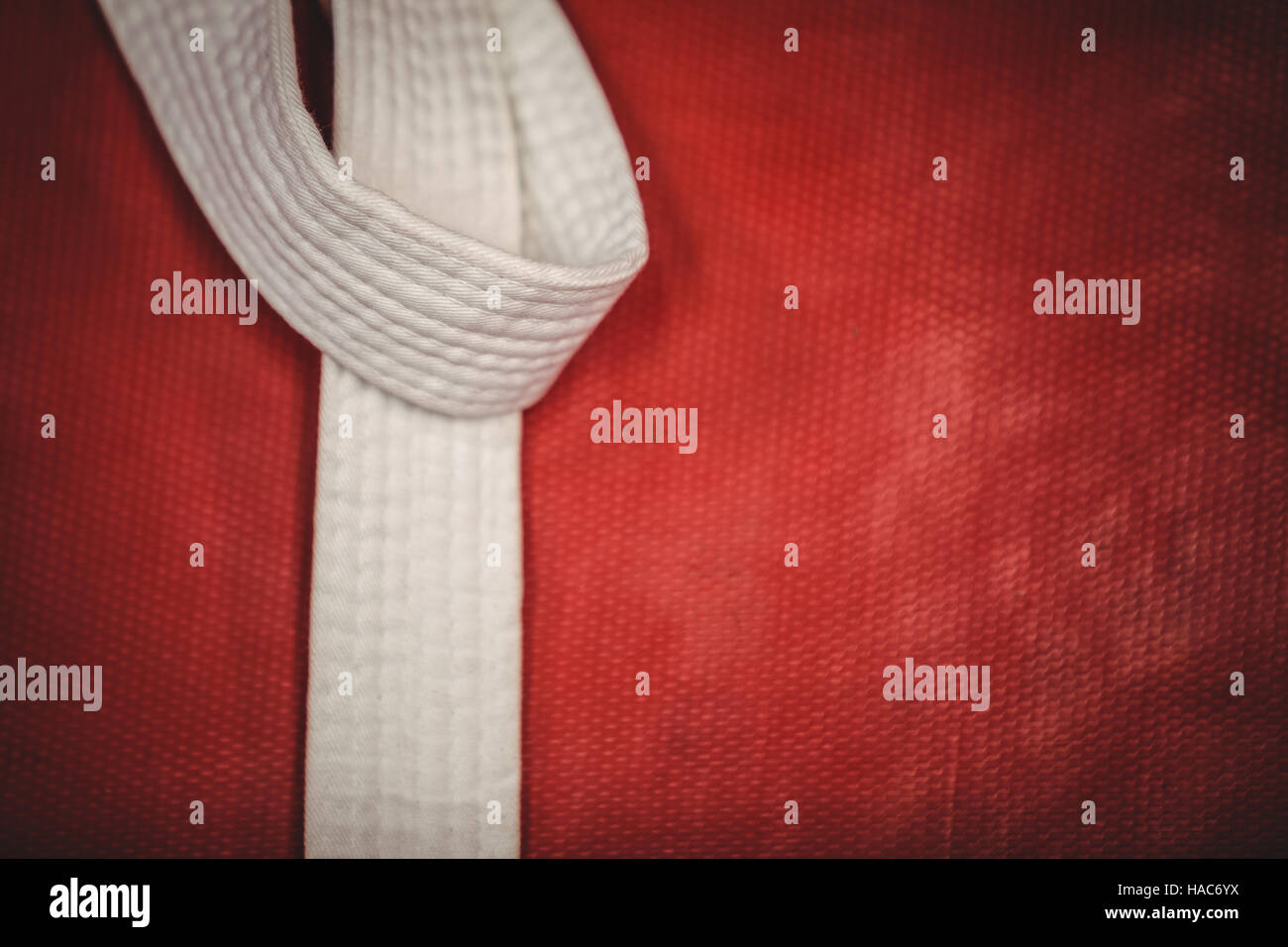 Karate white belt on red background Stock Photo - Alamy
