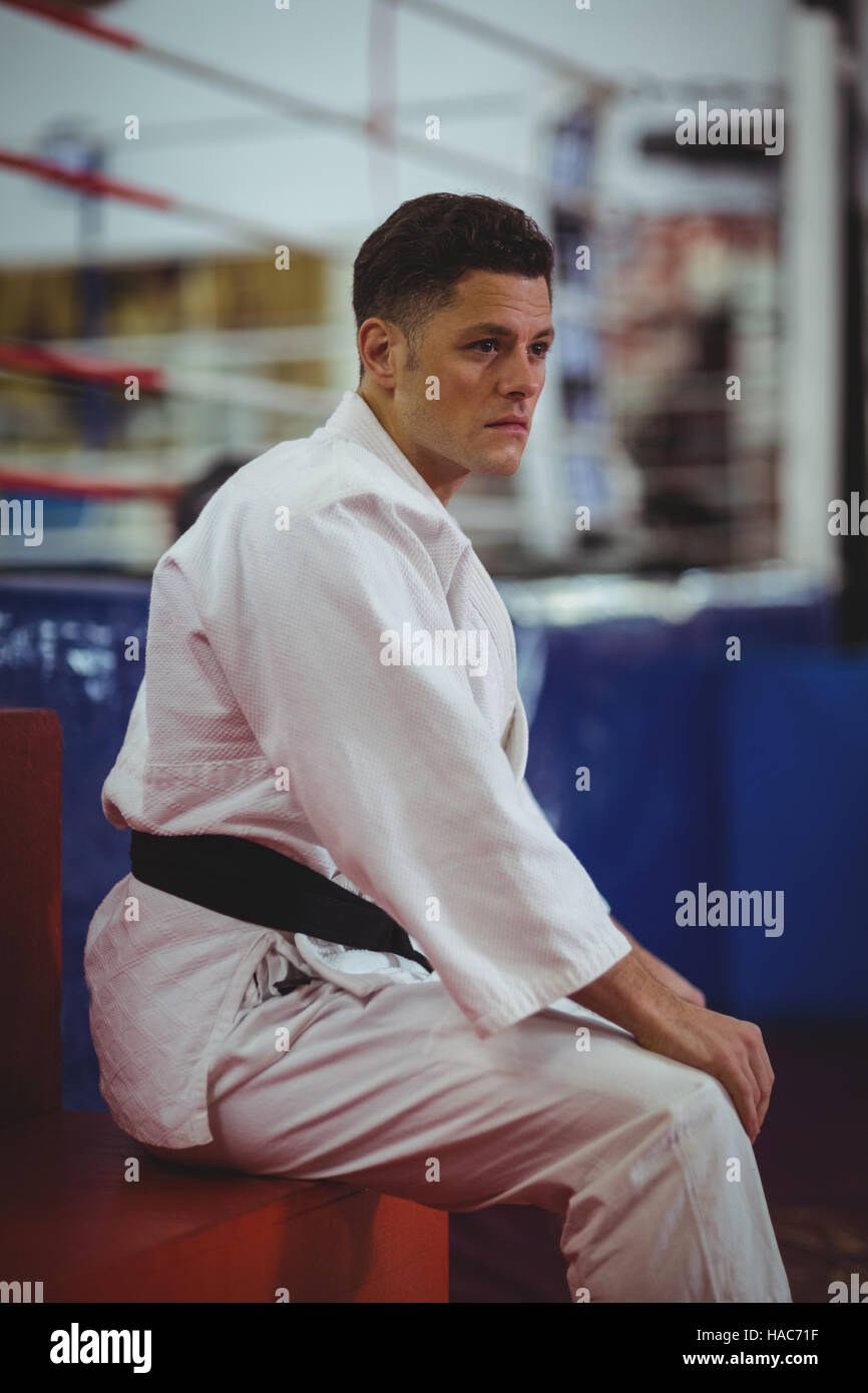Karate player sitting in fitness studio Stock Photo - Alamy
