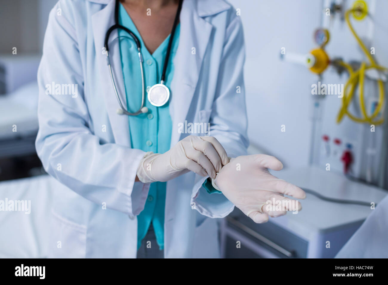 Doctor wearing gloves in hospital Stock Photo - Alamy