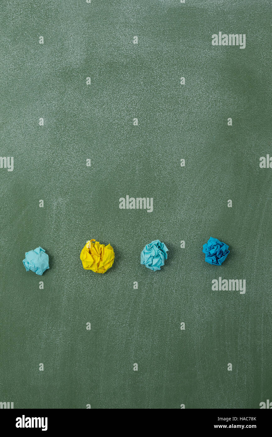 Colorful crumpled paper on a green background Stock Photo - Alamy