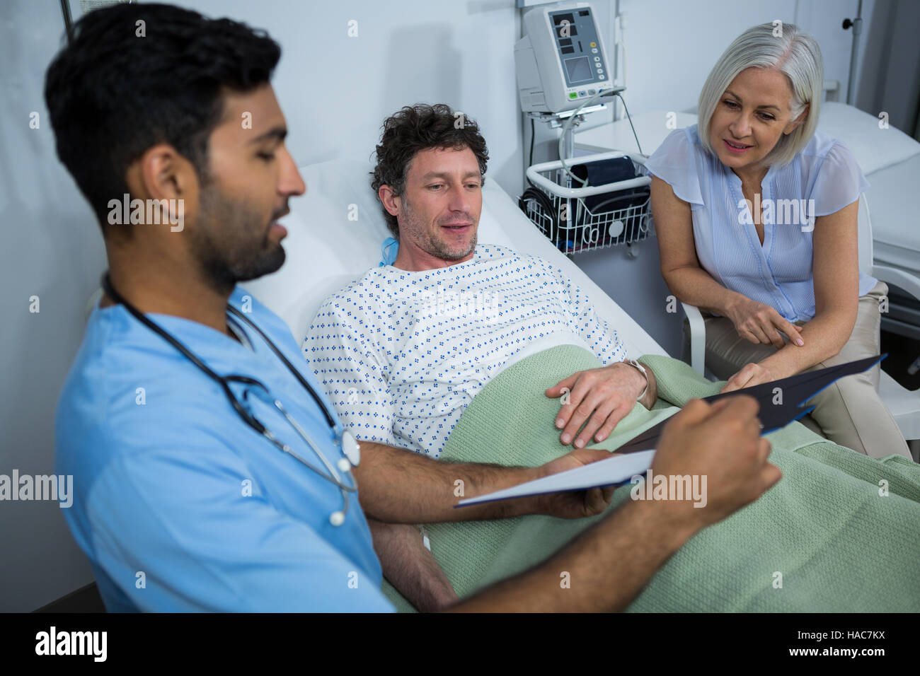Doctors showing medical report to patient Stock Photo - Alamy