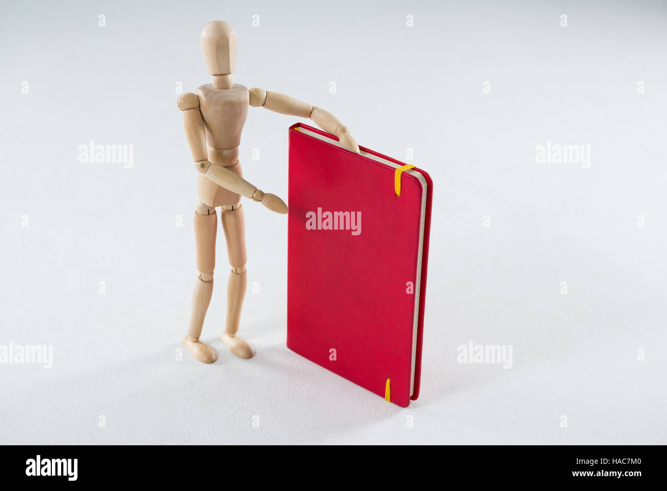 Wooden figurine showing a book Stock Photo - Alamy