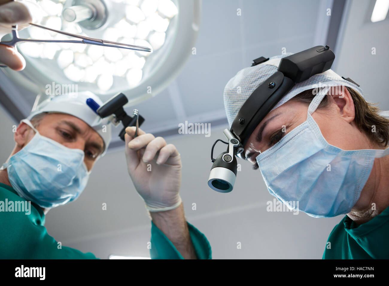 Surgeons holding surgical tool Stock Photo - Alamy