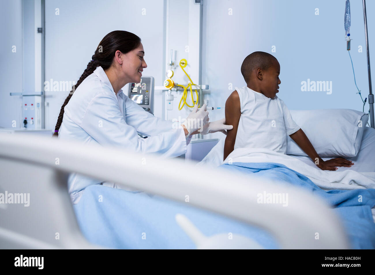 Female doctor giving an injection to patient in ward Stock Photo - Alamy