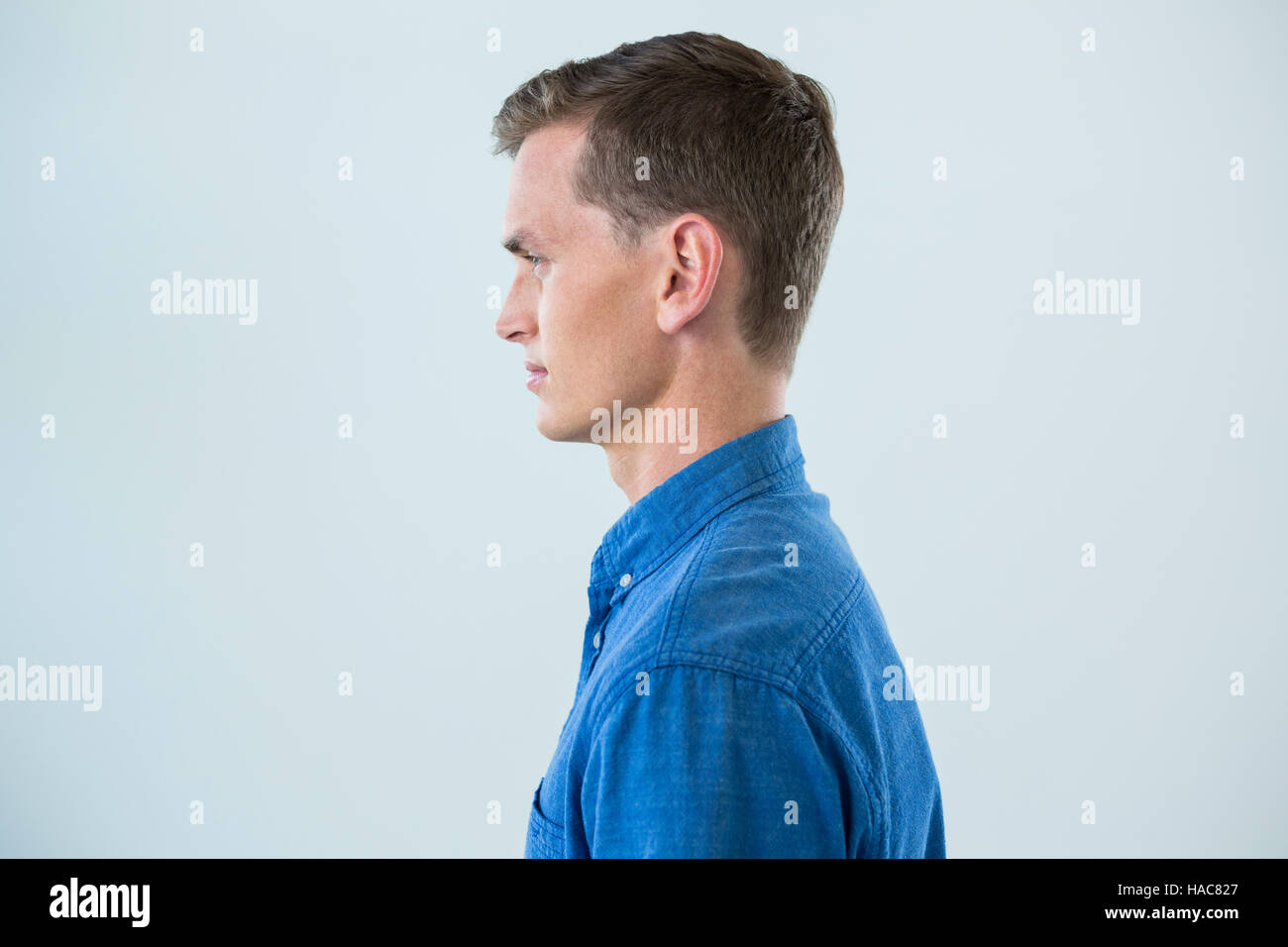 Side view of man in blue shirt Stock Photo - Alamy
