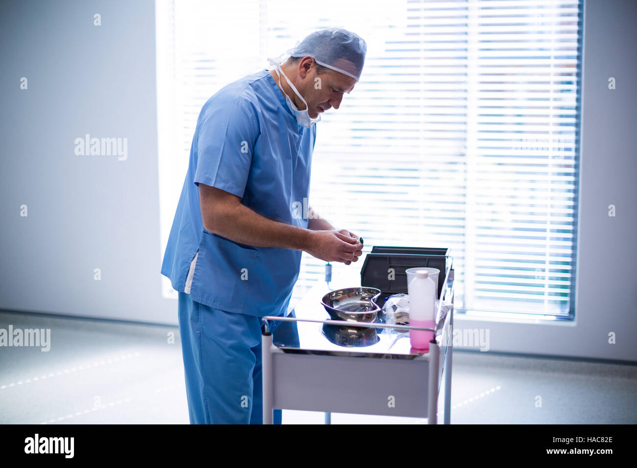 Surgeon holding medical tool Stock Photo - Alamy