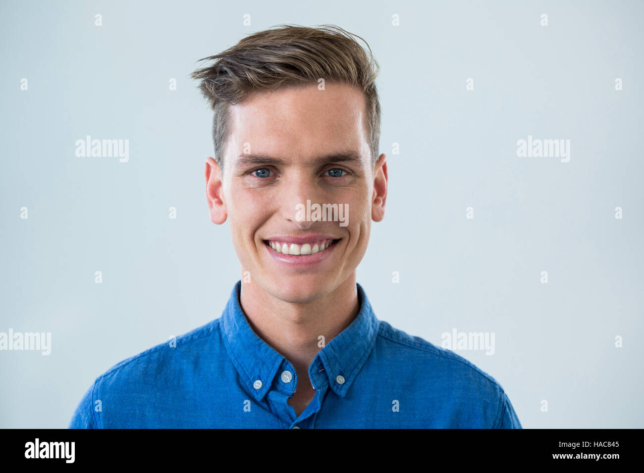 Smiling man blue shirt hi-res stock photography and images - Alamy