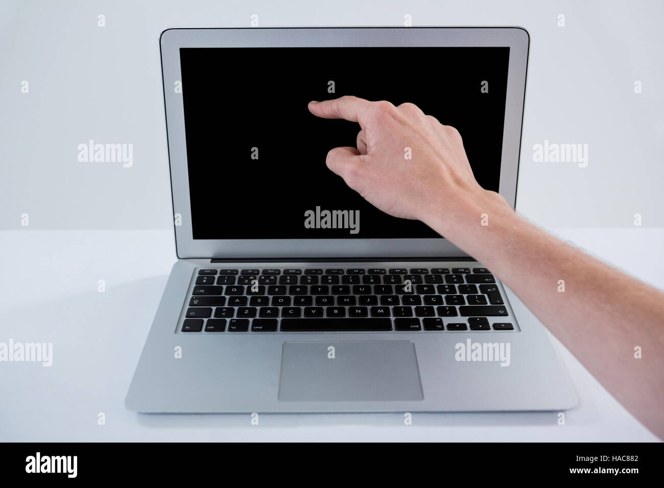 Man pointing at laptop Stock Photo - Alamy