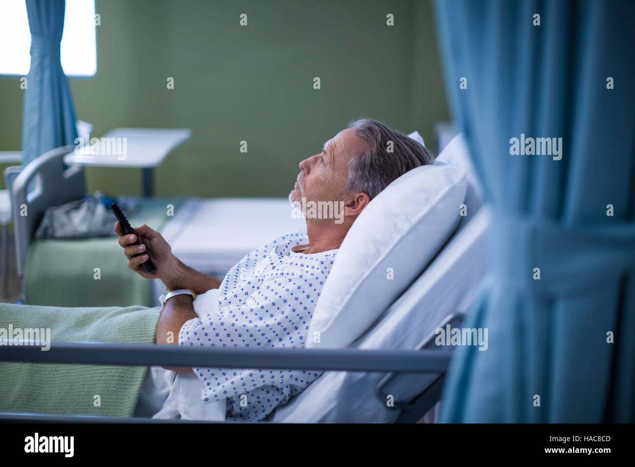 Patient watching television on the bed Stock Photo - Alamy