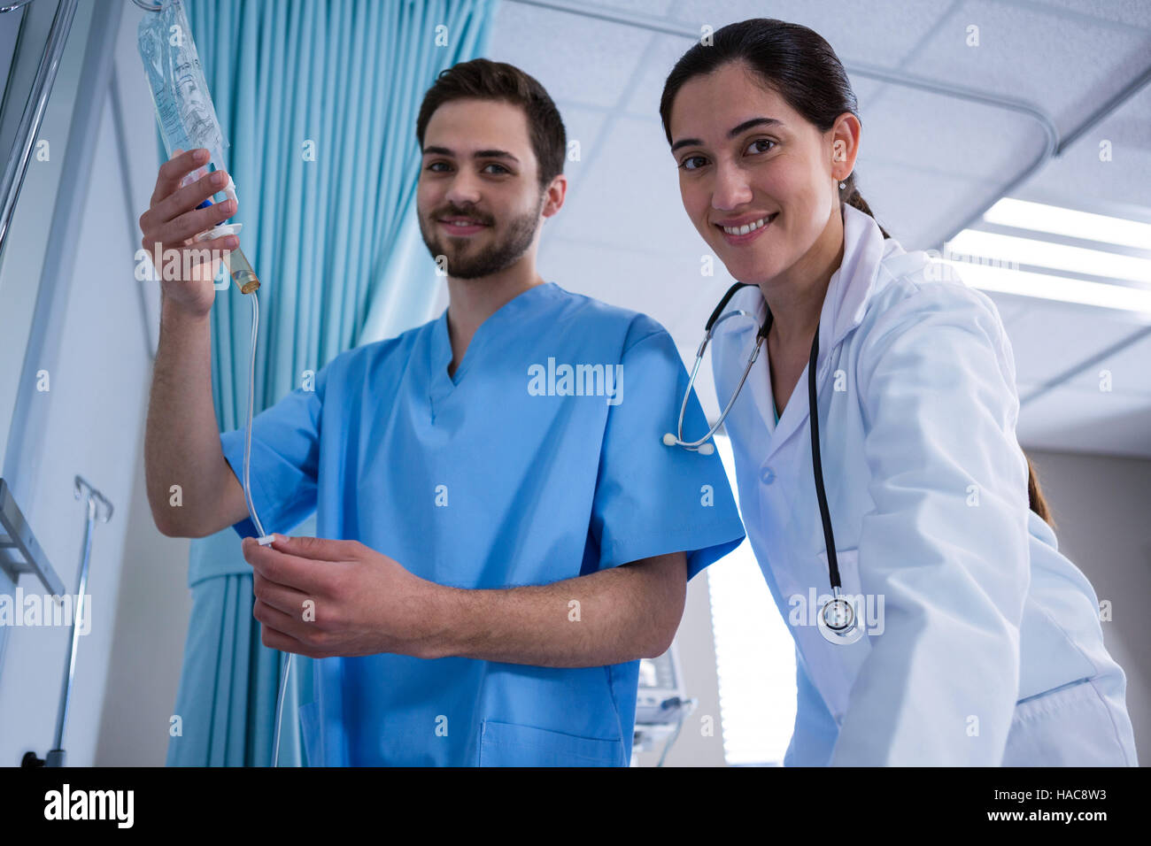 Doctor adjusting iv drip Stock Photo - Alamy