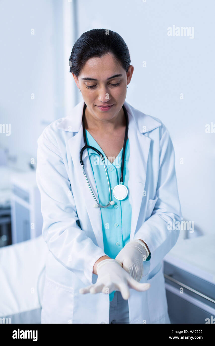 Doctor wearing gloves hi-res stock photography and images - Alamy