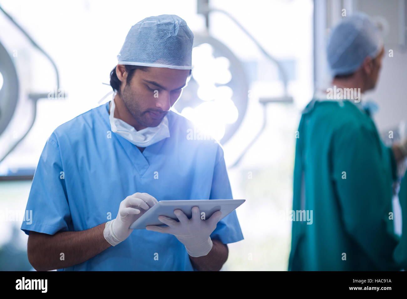 Surgeon using digital tablet in operation room Stock Photo - Alamy