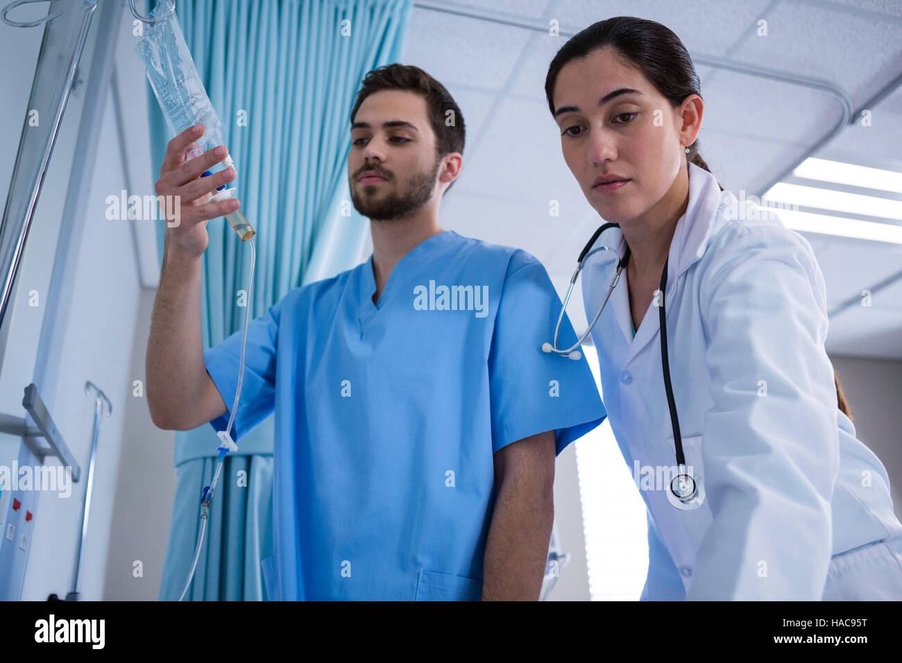 Male doctor checking intravenous therapy hi-res stock photography and ...