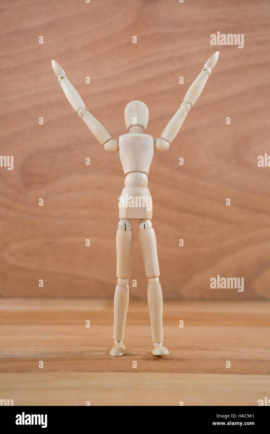 Wooden figurine standing with hand raised Stock Photo - Alamy