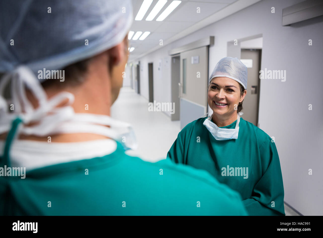 Surgeons interacting with each other in corridor Stock Photo - Alamy