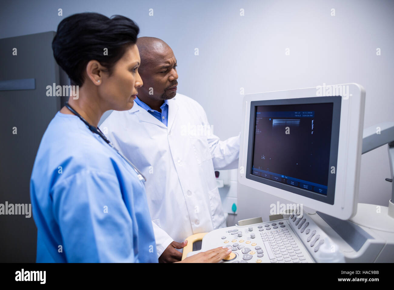 Doctor and nurse using patient monitoring machine in ward Stock Photo ...