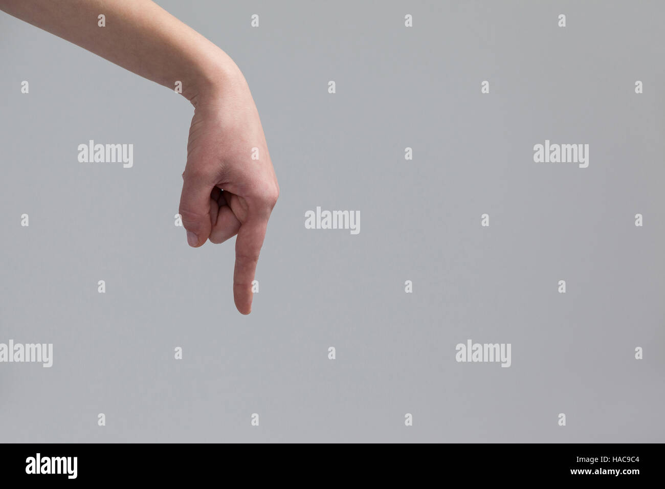 Hand of a woman pointing downwards Stock Photo - Alamy