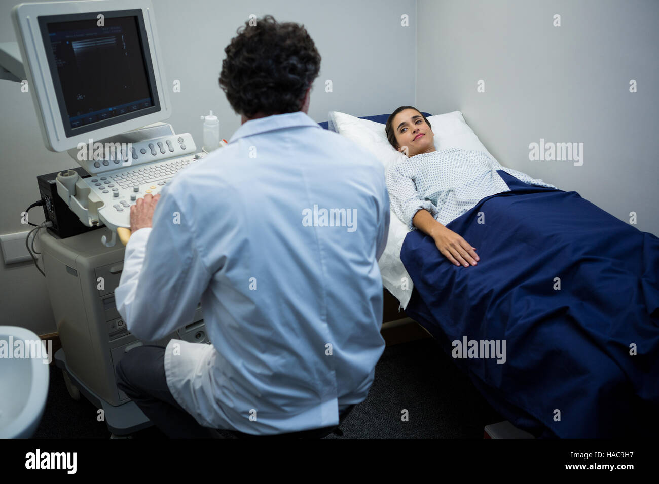 Doctor using sonography machine Stock Photo - Alamy