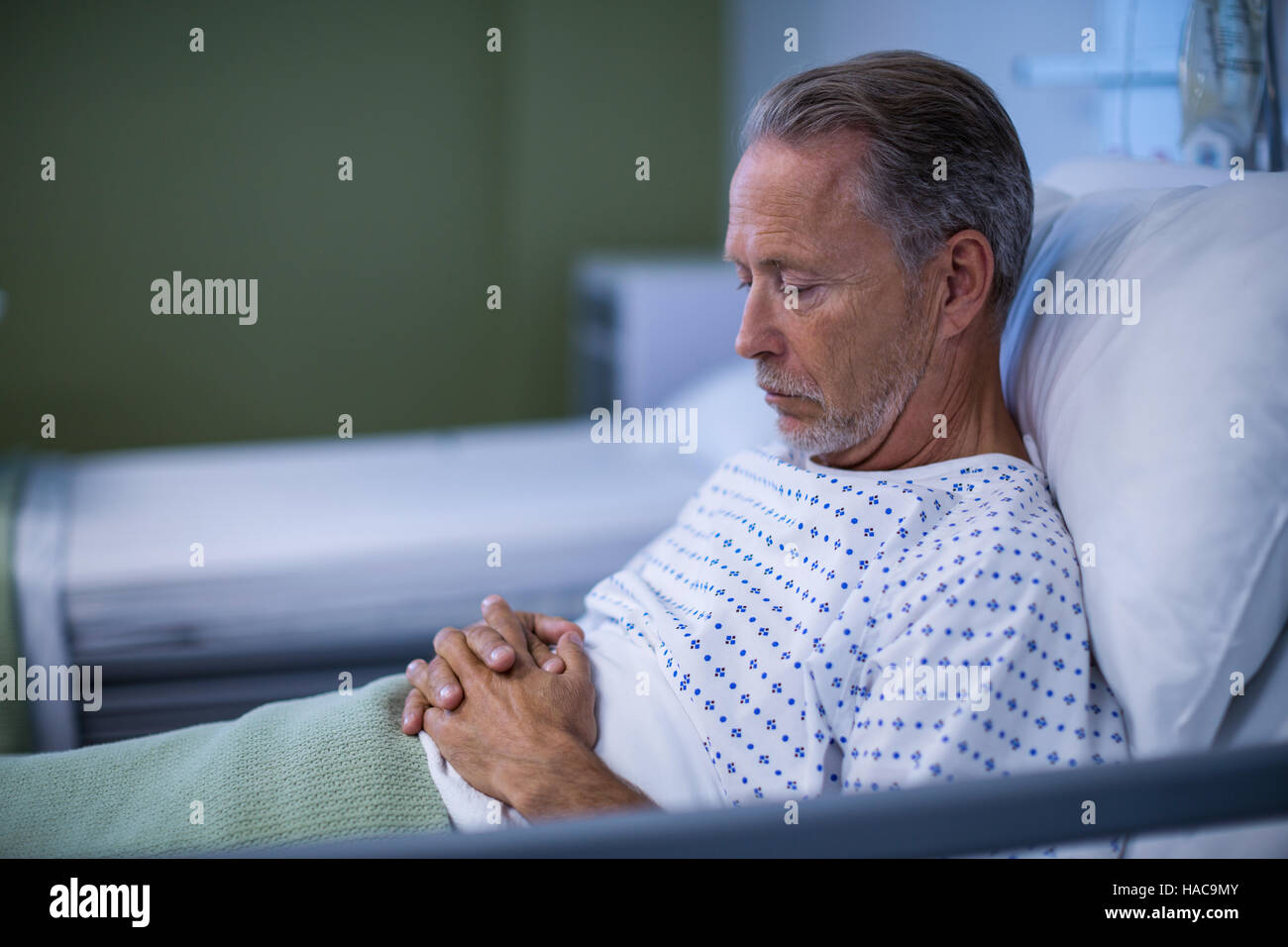 Sick patient sitting on bed Stock Photo - Alamy